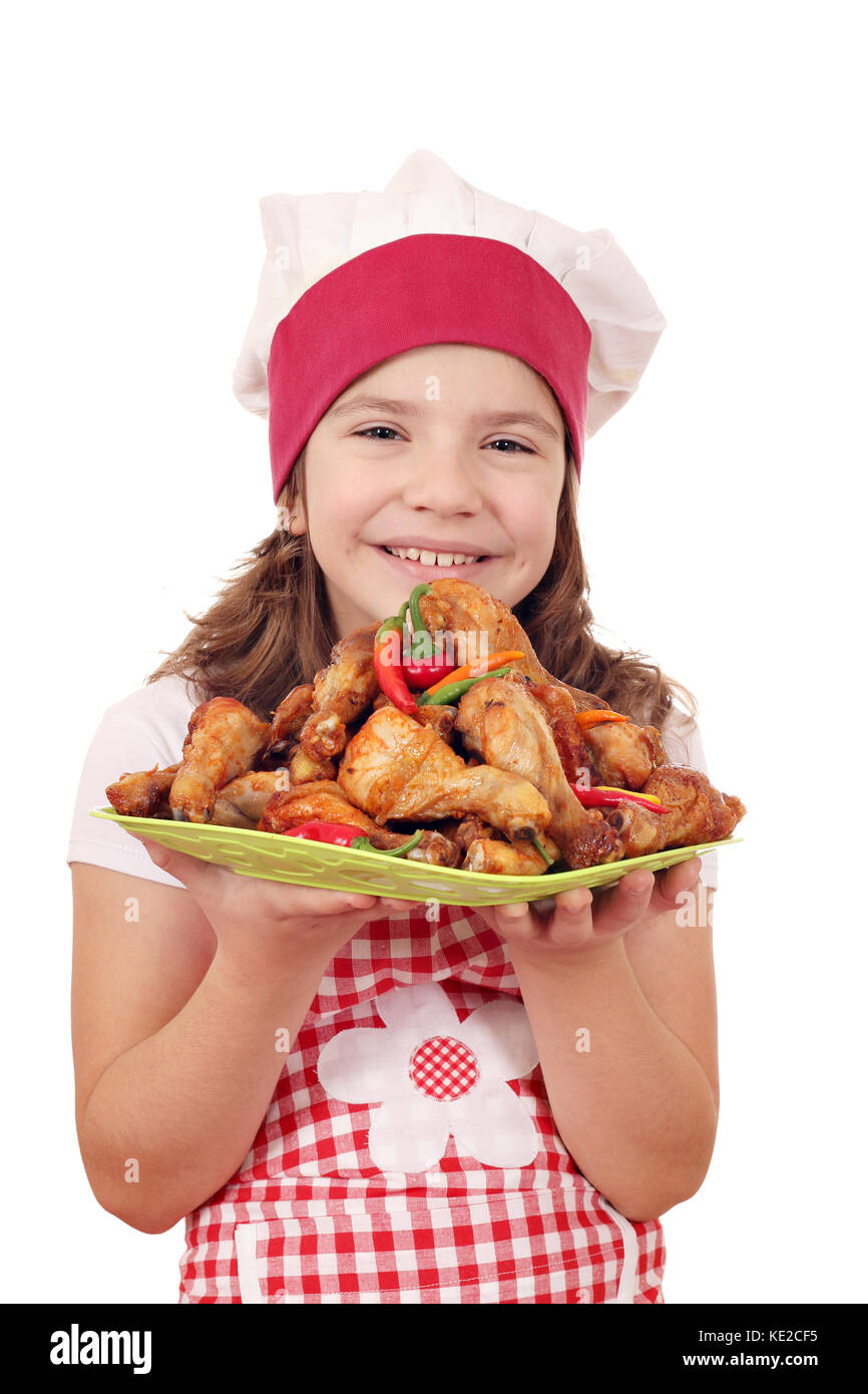 happy little girl cook with roasted chicken drumstick on plate Stock ...