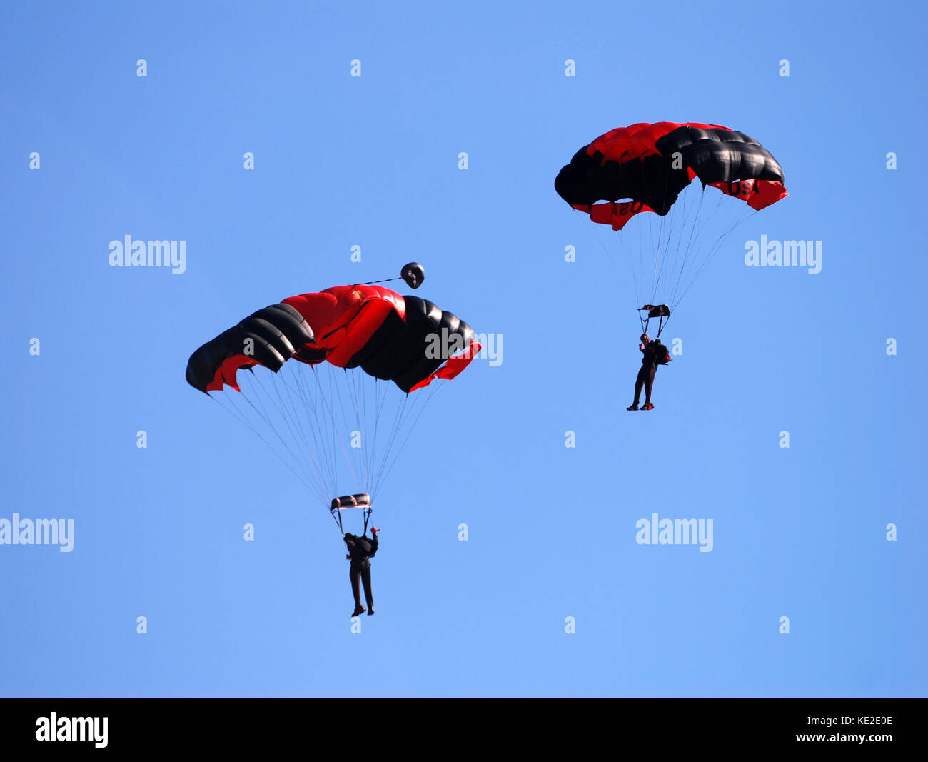 Two parachutes against blue sky Stock Photo - Alamy