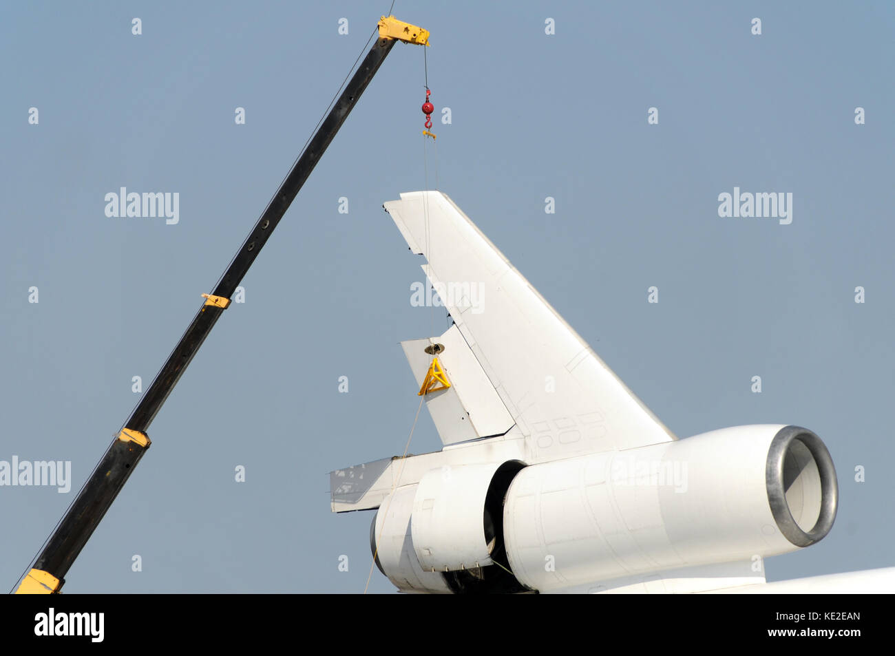 Crane repairing jet airplane's tail and rudder Stock Photo - Alamy