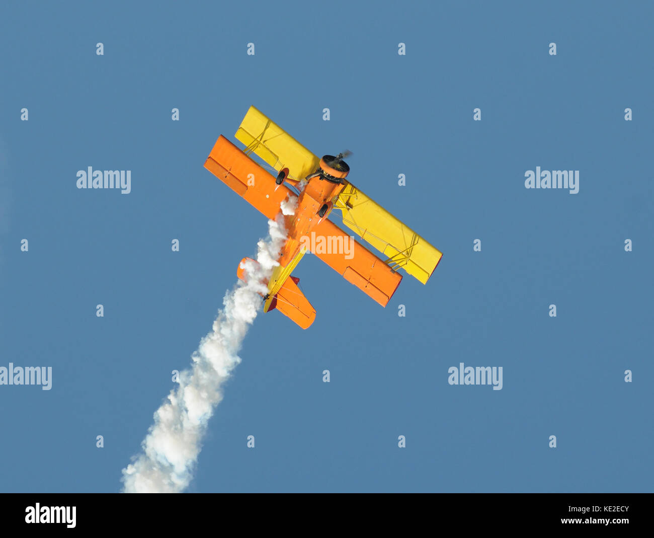 Old yellow biplane performing aerobatics Stock Photo - Alamy
