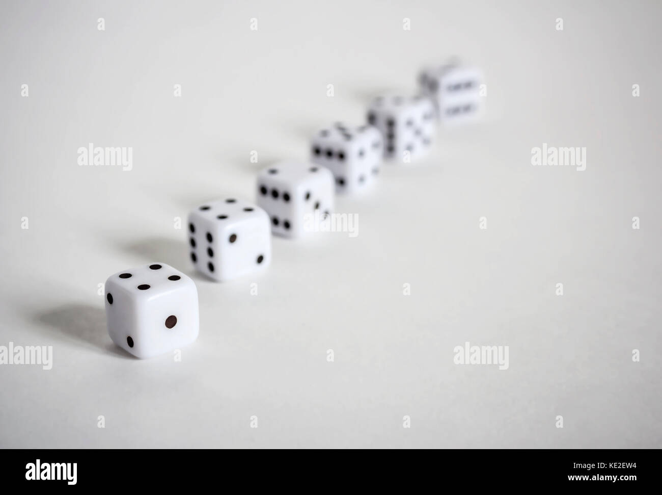White dices in a row or scattered on white background soft focus Stock ...