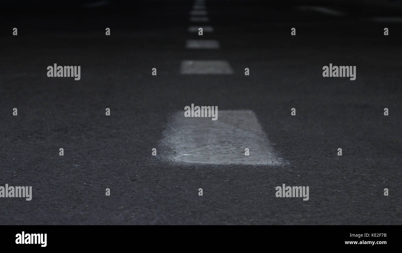 Street lane lines on asphalt in closeup Stock Photo - Alamy