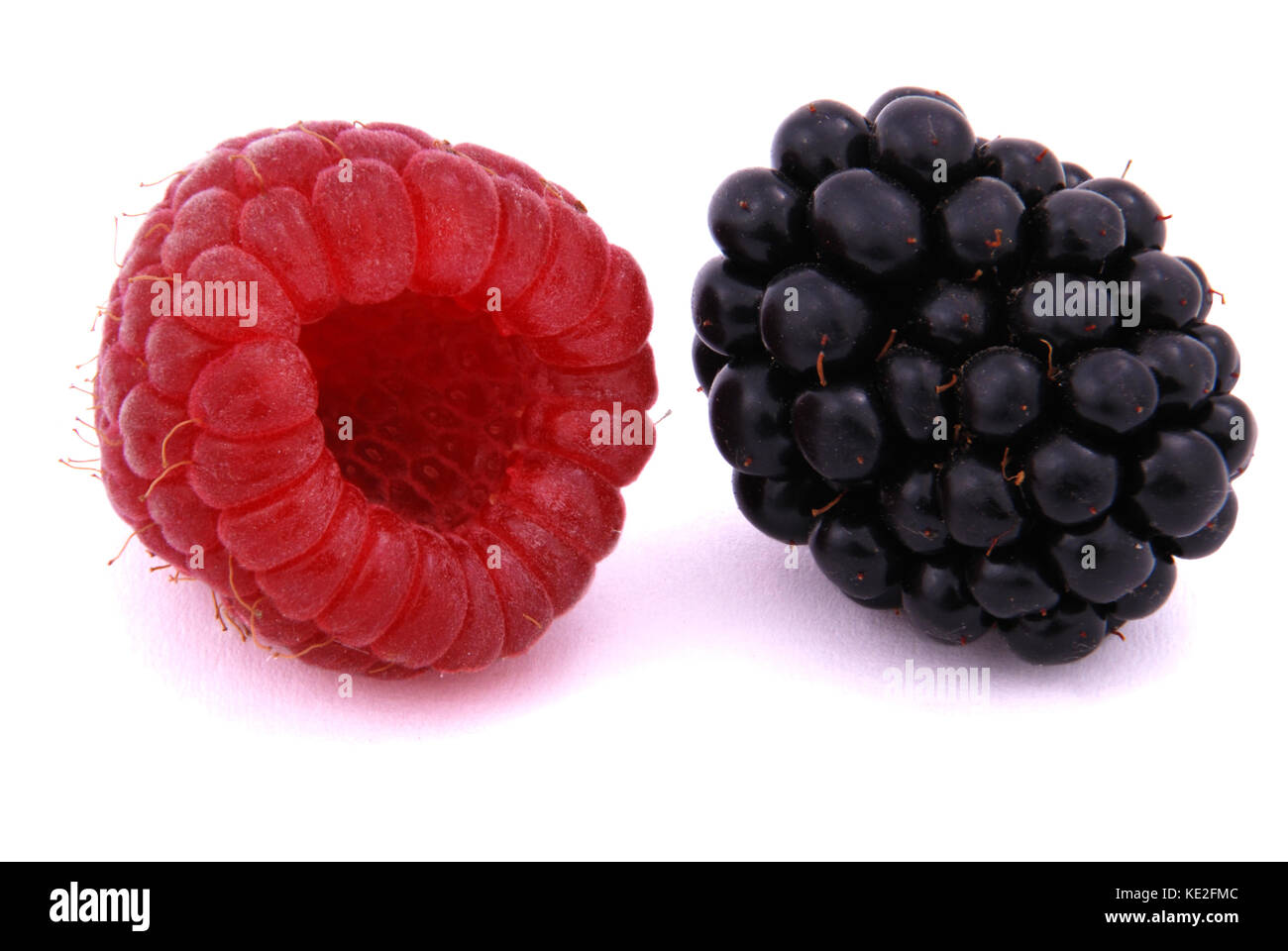 Raspberries and blackberries on white background Stock Photo - Alamy
