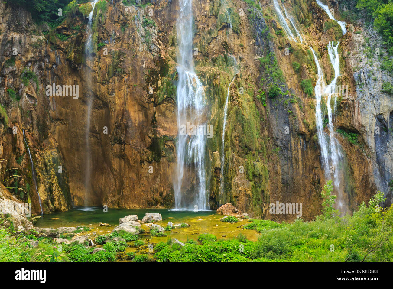 Close up of blue waterfalls in a green forest during daytime in Summer ...