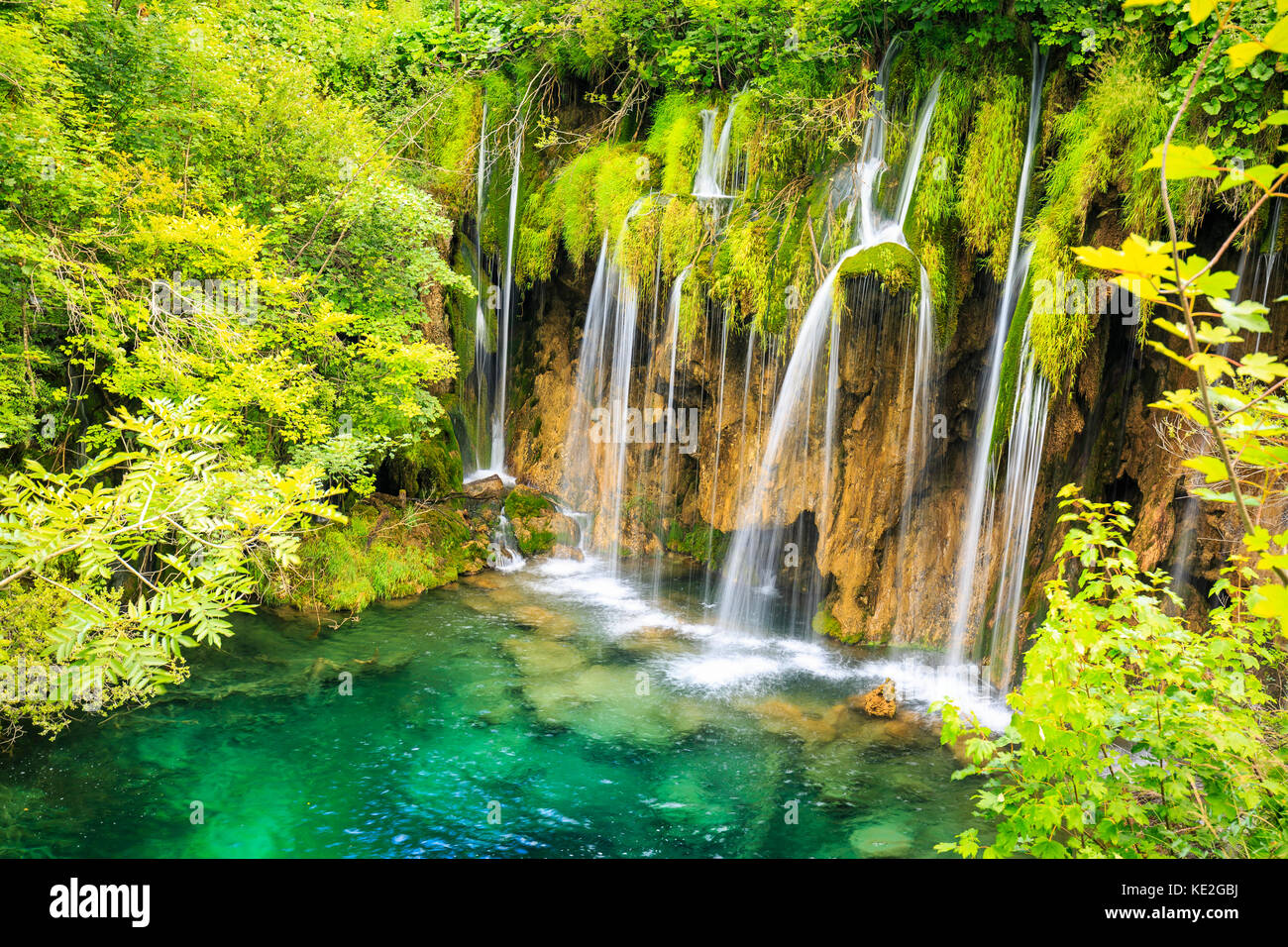 Close up of blue waterfalls in a green forest during daytime in Summer ...