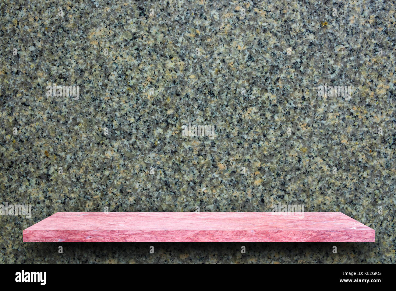 Empty top of pink granite stone table on the granite wall background ...