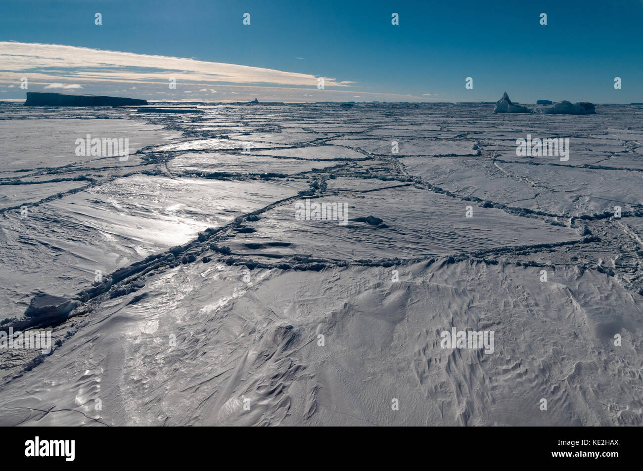 Thick snow-covered pack-ice and trapped icebergs, Antarctica Stock ...