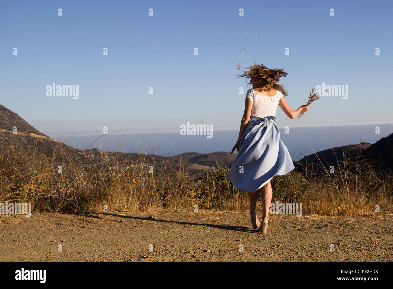 Girl Dancing by the Ocean Stock Photo - Alamy