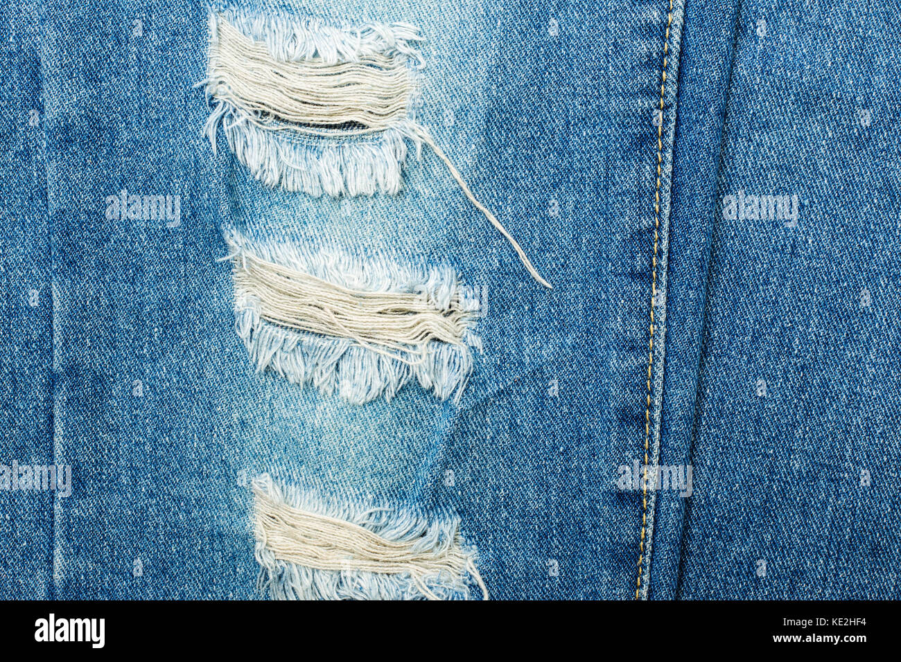 Rip denim jeans background with seam of jeans fashion design Stock ...