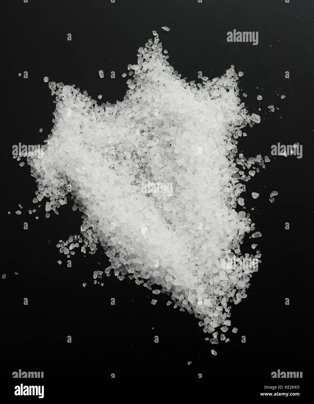 pile of salt on black background Stock Photo - Alamy