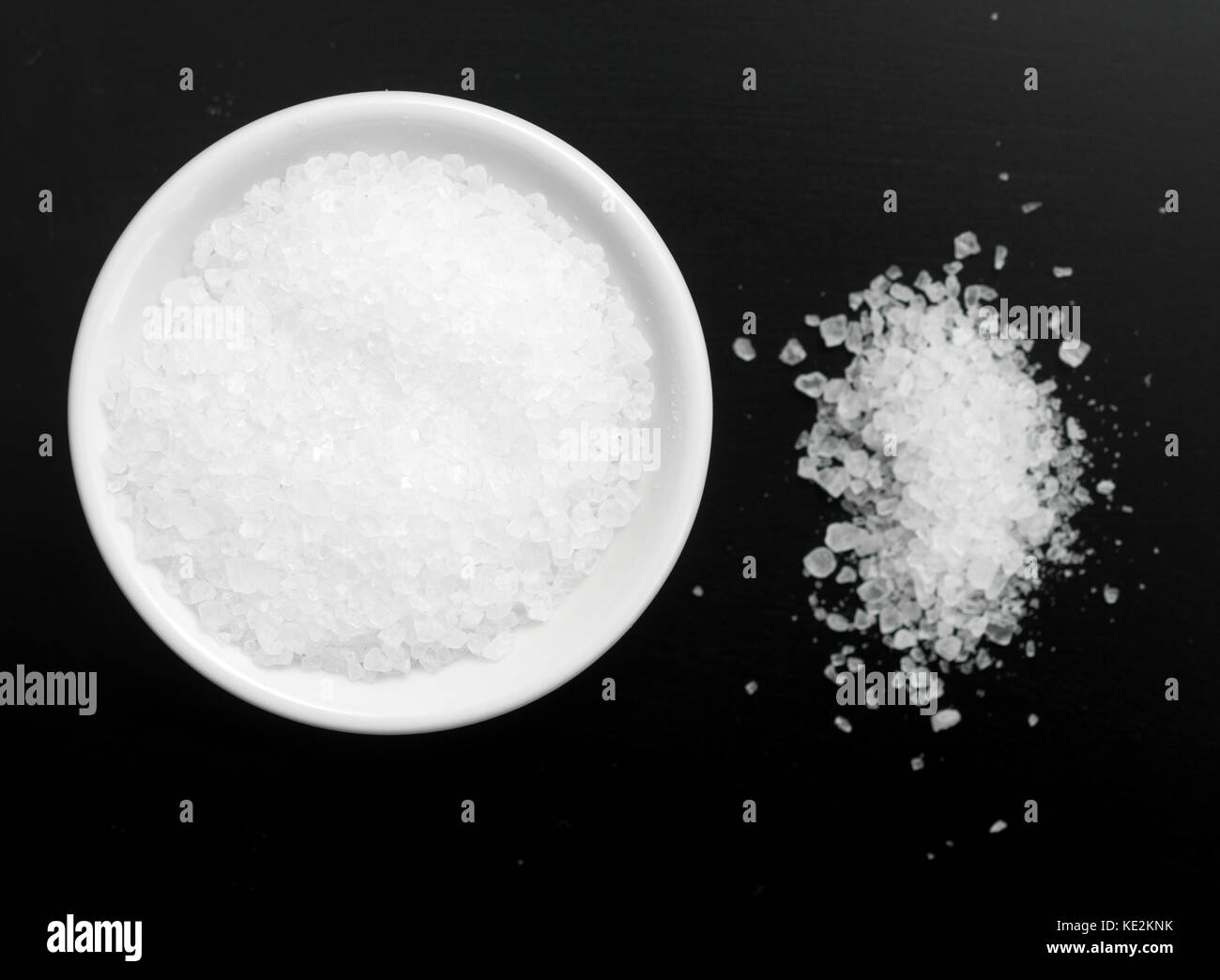 sea salt on a black background Stock Photo - Alamy
