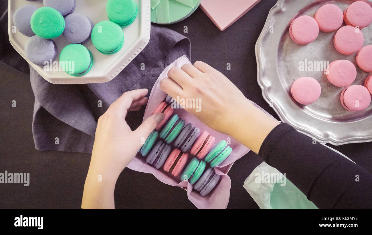 Step by step. Packaging french macarons into gift boxes Stock Photo - Alamy