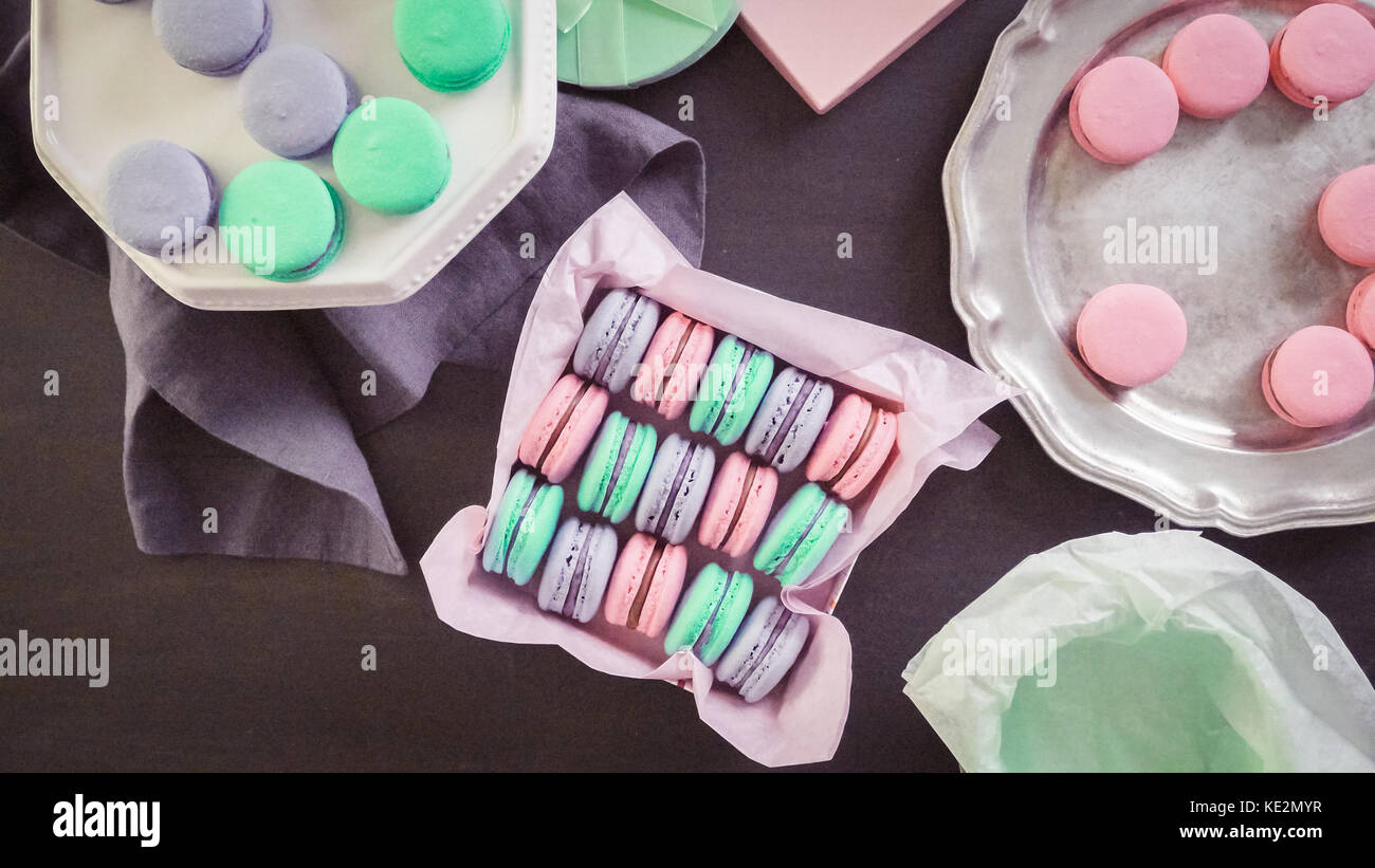 Step by step. Packaging french macarons into gift boxes Stock Photo - Alamy
