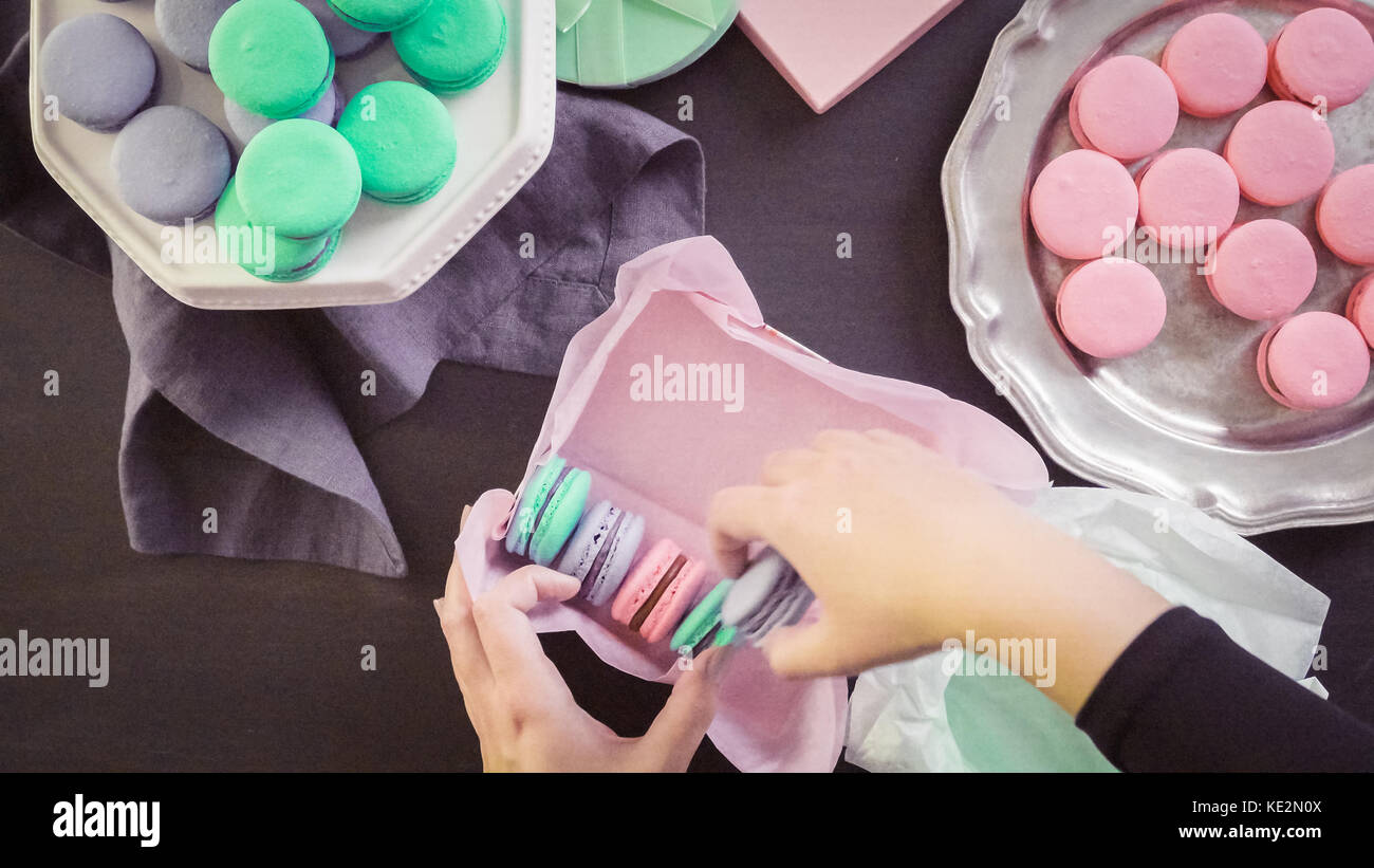 Step by step. Packaging french macarons into gift boxes Stock Photo - Alamy