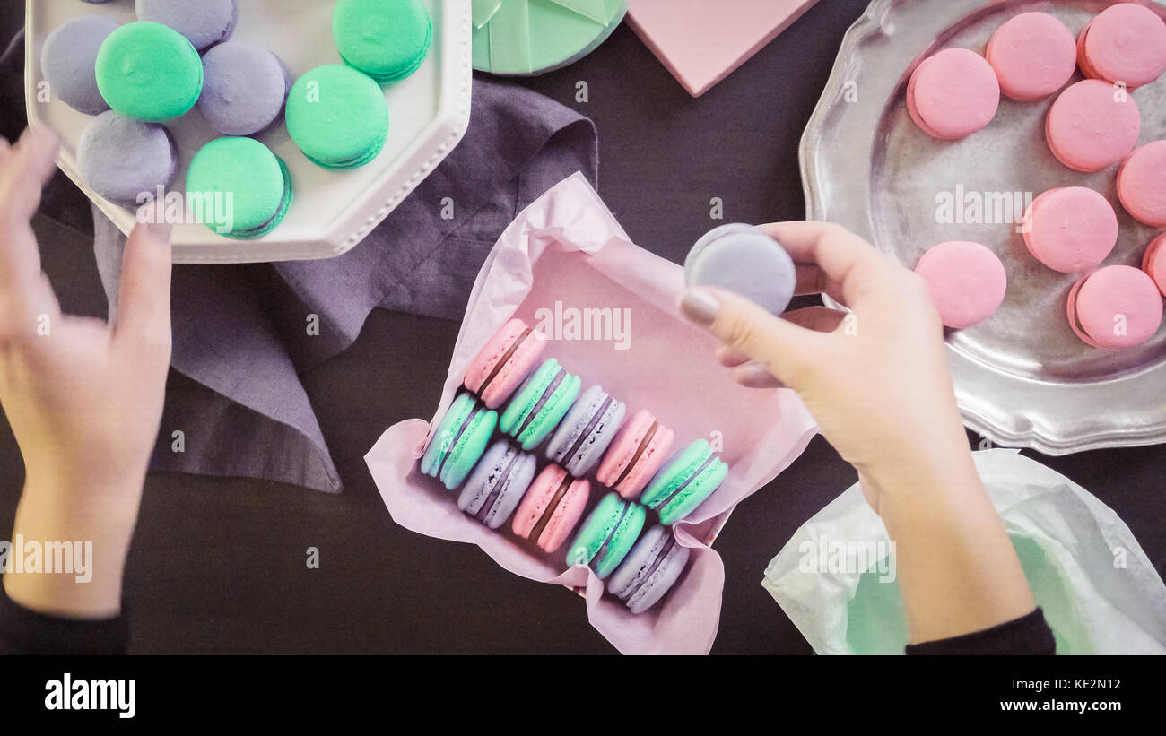 Step by step. Packaging french macarons into gift boxes Stock Photo - Alamy