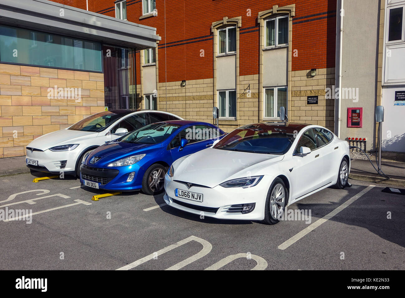 Tesla electric cars at charging point, Manchester Stock Photo - Alamy
