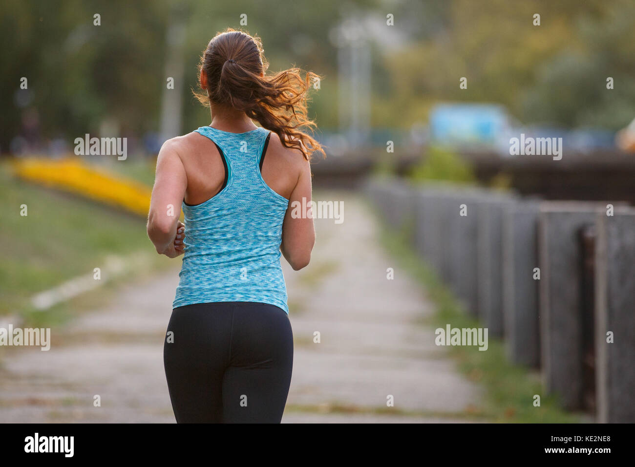 Back view young woman on pavement in hi-res stock photography and ...