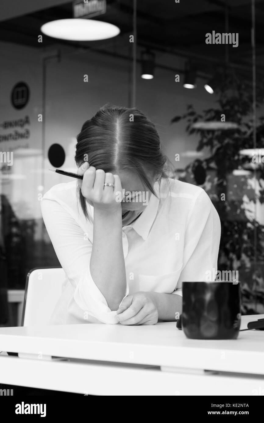 The young woman in the office, creates a new project, laughing ...