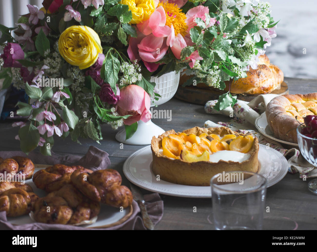 Festive table with big bouquet, homemade cakes and scones Stock Photo ...