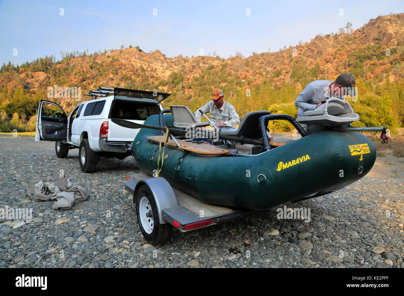 A couple of fly fisherman ready their raft for a float fishing trip ...