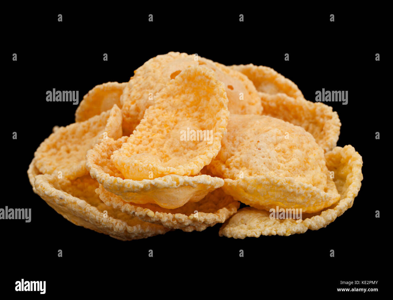 Corn flakes snack isolated on black background Stock Photo - Alamy