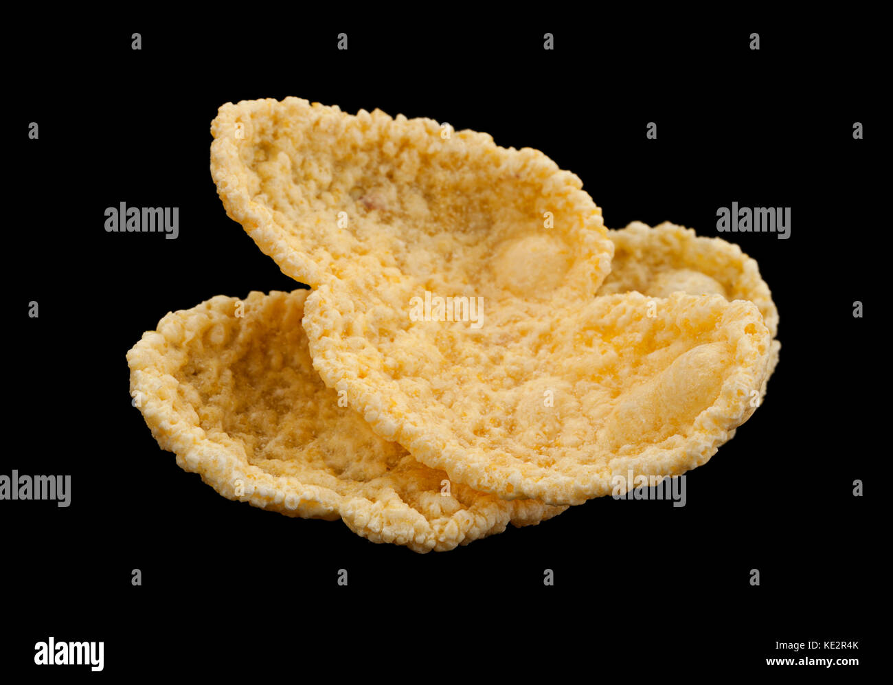 Corn flakes snack isolated on black background Stock Photo - Alamy