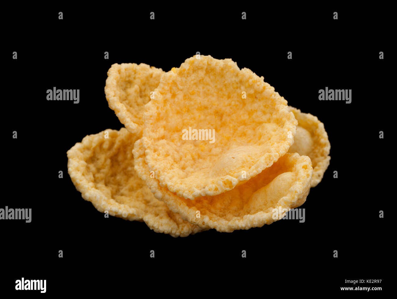 Corn flakes snack isolated on black background Stock Photo - Alamy
