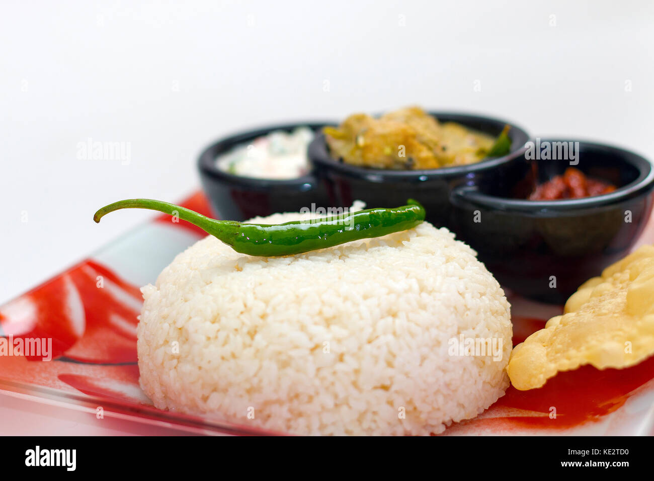Indian Gee rice with complete curry meal served on a tray in a ...