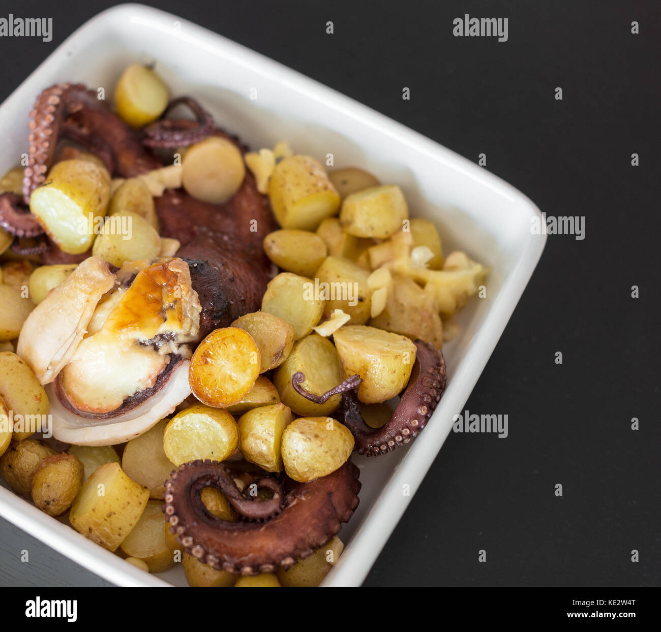 Plate with Baked Octopus with Potatoes Stock Photo - Alamy