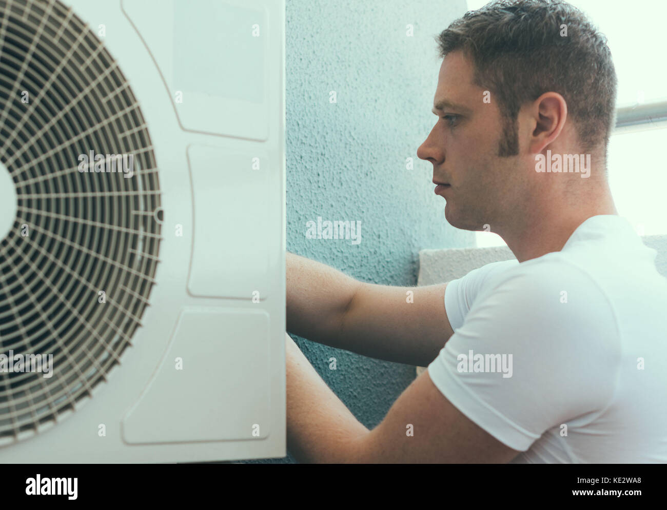 Technician is installing an air conditioner hi-res stock photography ...