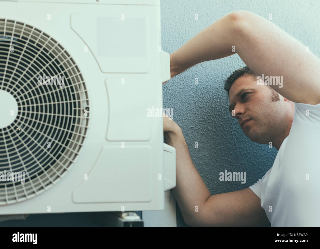 Male technician installing air-conditioning system Stock Photo - Alamy