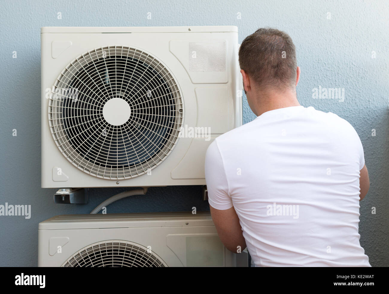 Male technician installing air-conditioning system Stock Photo - Alamy
