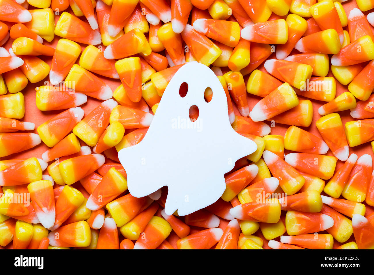 Halloween candy corn background with white ghost Stock Photo - Alamy
