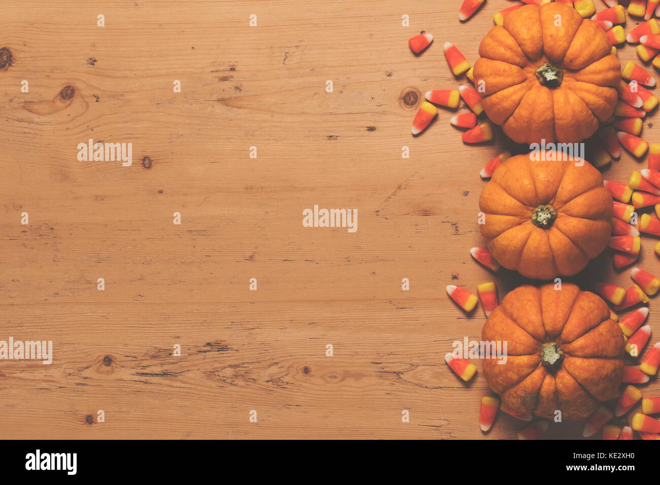Pumpkin and candy corn autumn halloween background Stock Photo - Alamy