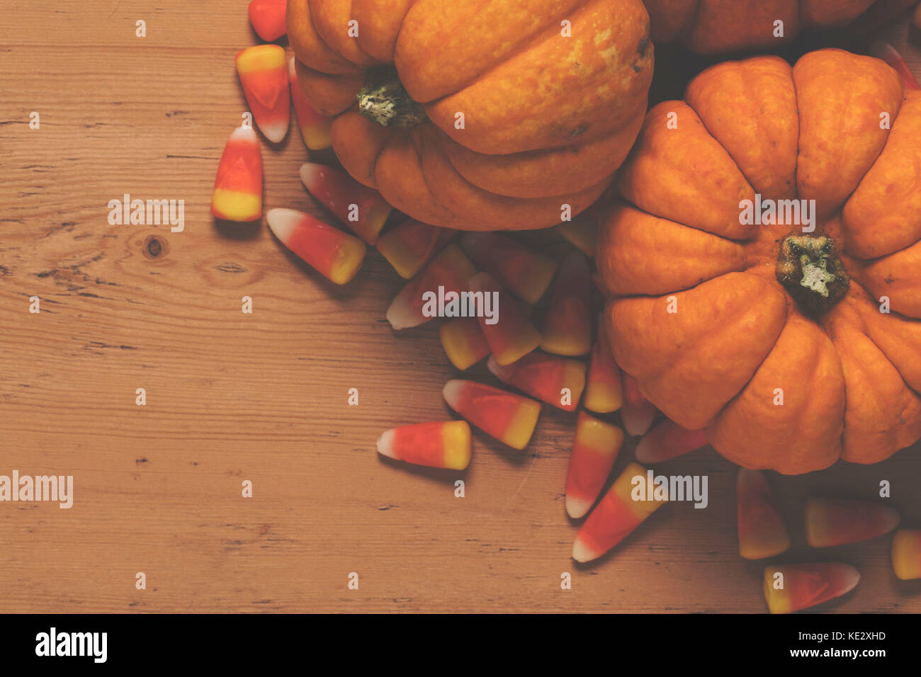 Pumpkin and candy corn autumn halloween background Stock Photo - Alamy