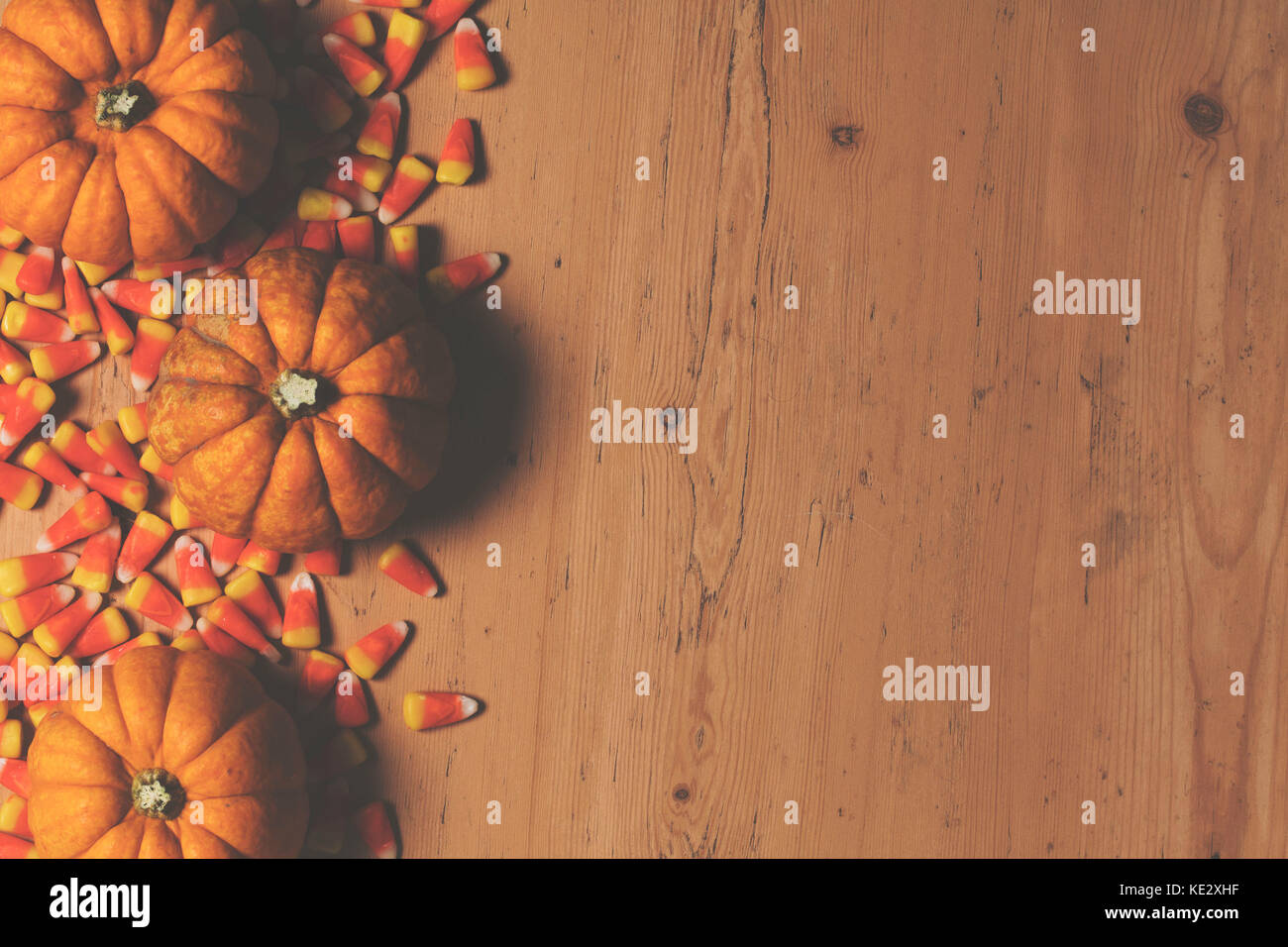 Pumpkin and candy corn autumn halloween background Stock Photo - Alamy