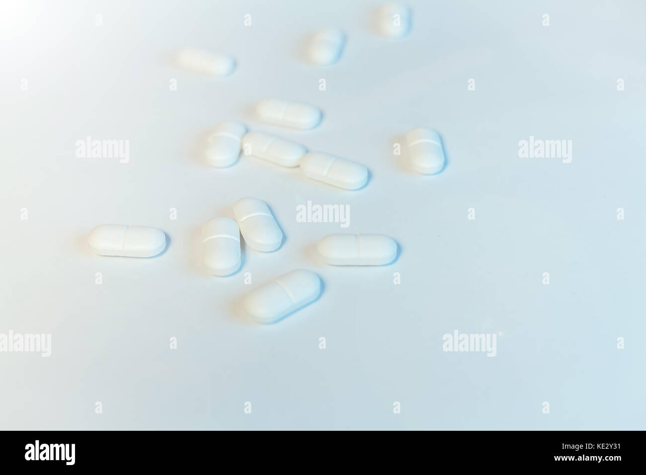 White capsules RX medication isolated on white backdrop, Container ...