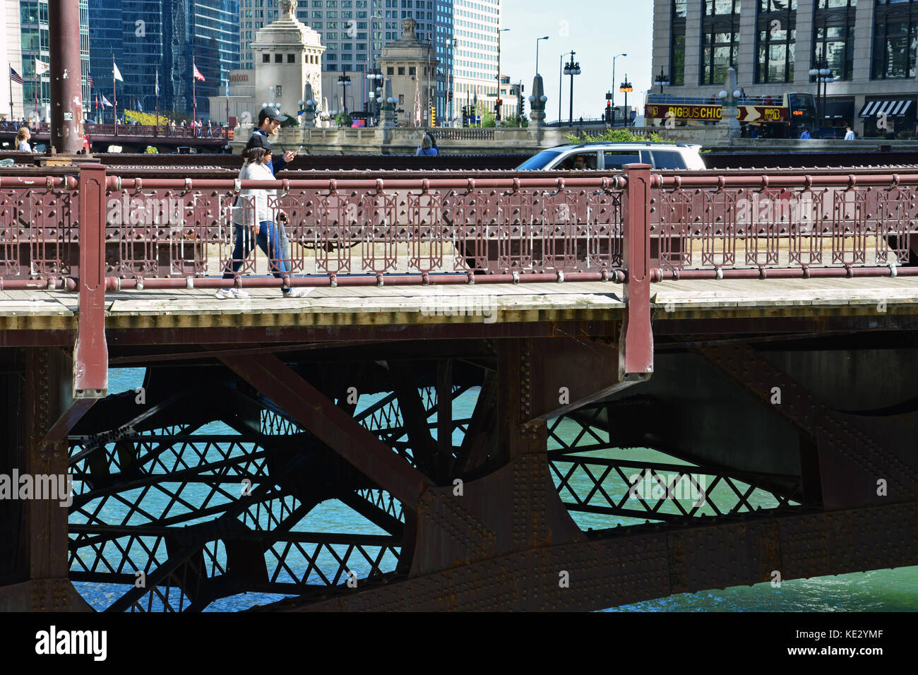 Two people cross the Chicago River on the Wabash Avenue Bridge in ...