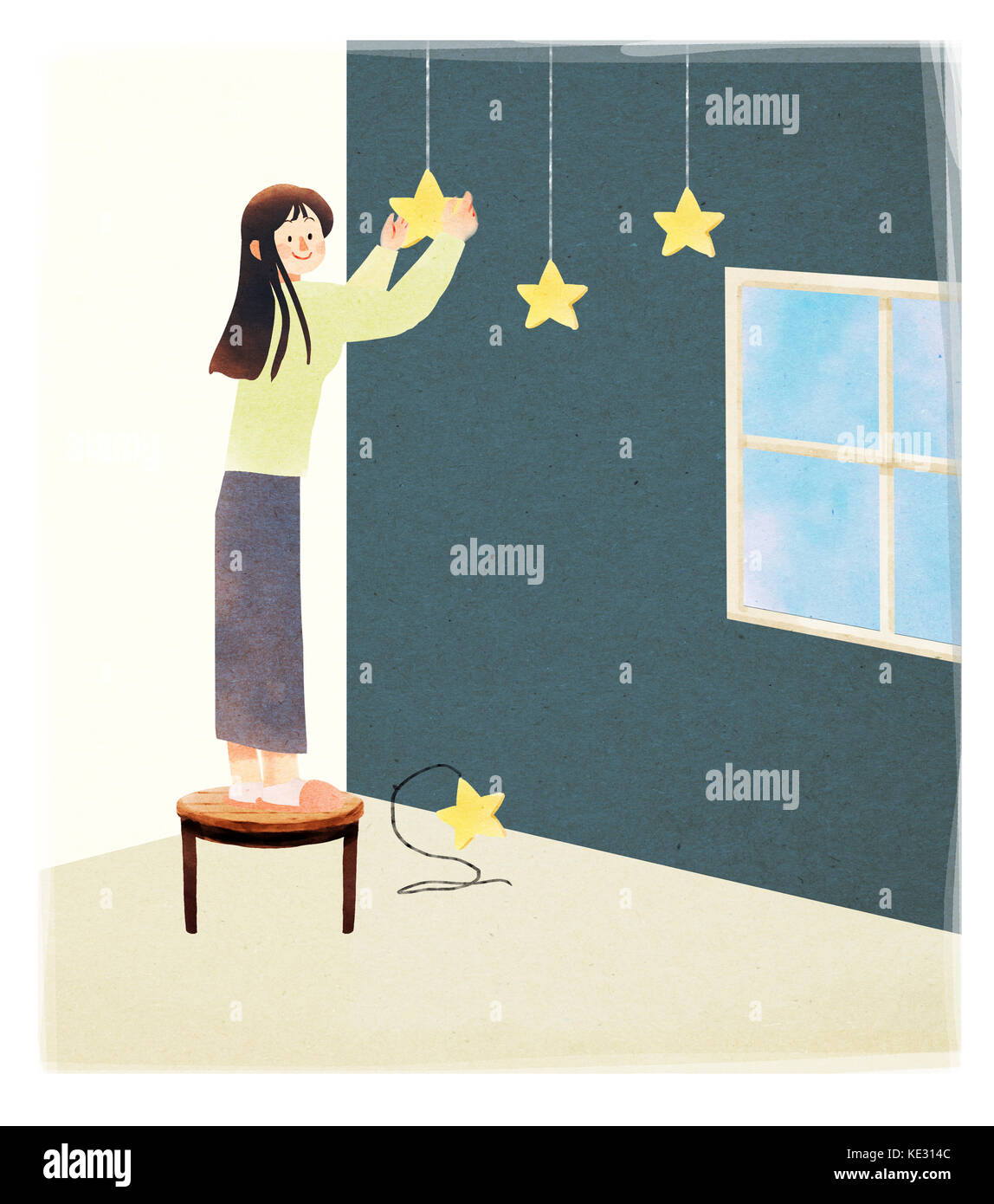 Smiling woman hanging stars on ceiling Stock Photo - Alamy