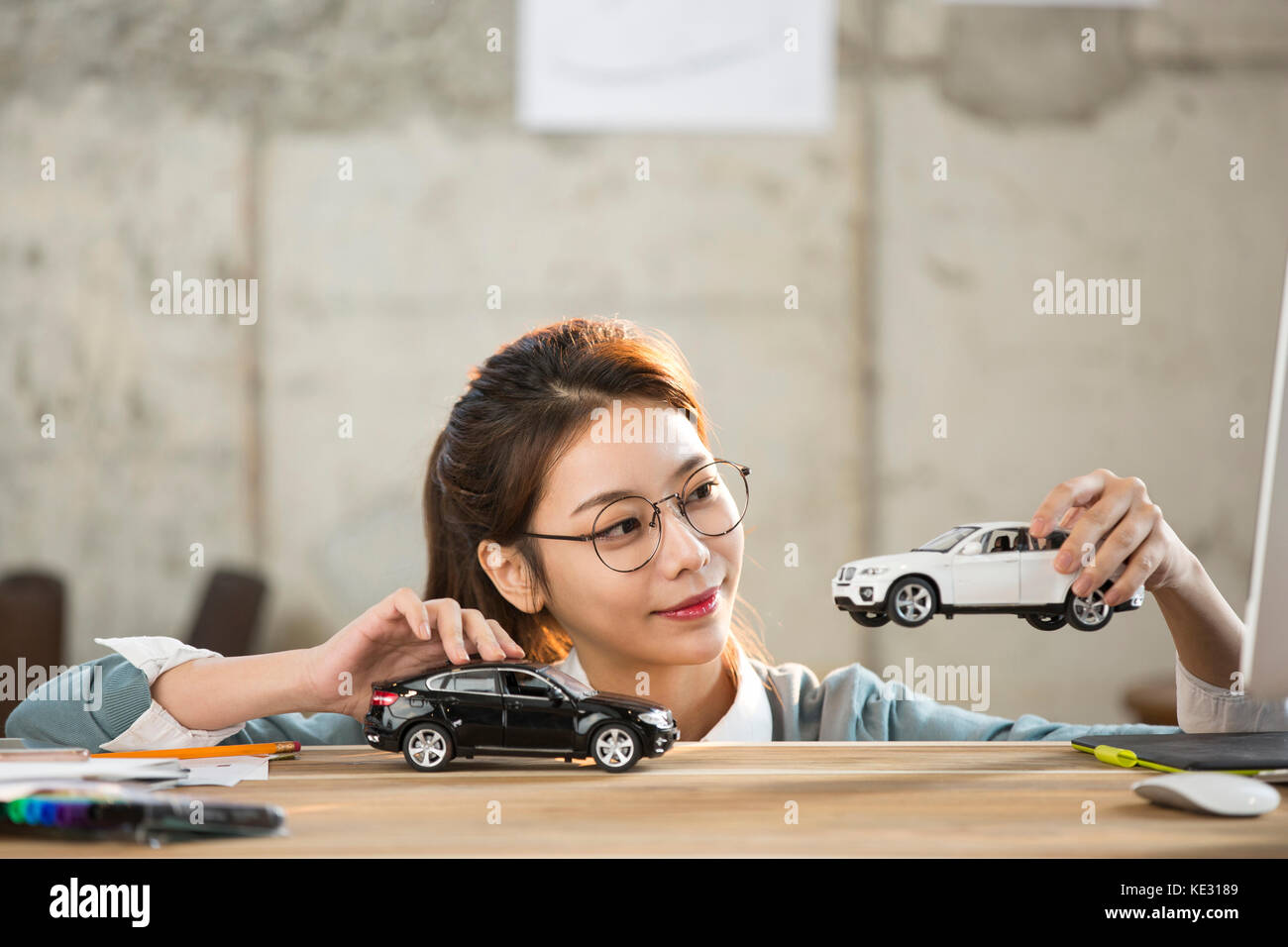 Portrait of young smiling female car designer at work Stock Photo - Alamy