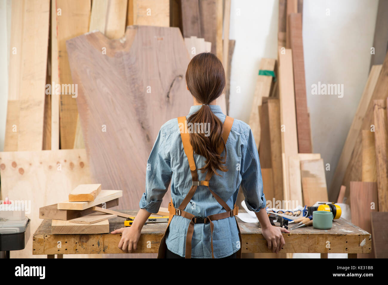 Back of young female woodworker at work Stock Photo - Alamy
