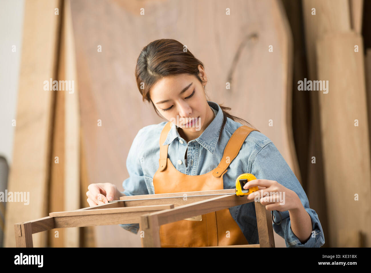 Portrait of young female woodworker concentrating on her work Stock ...