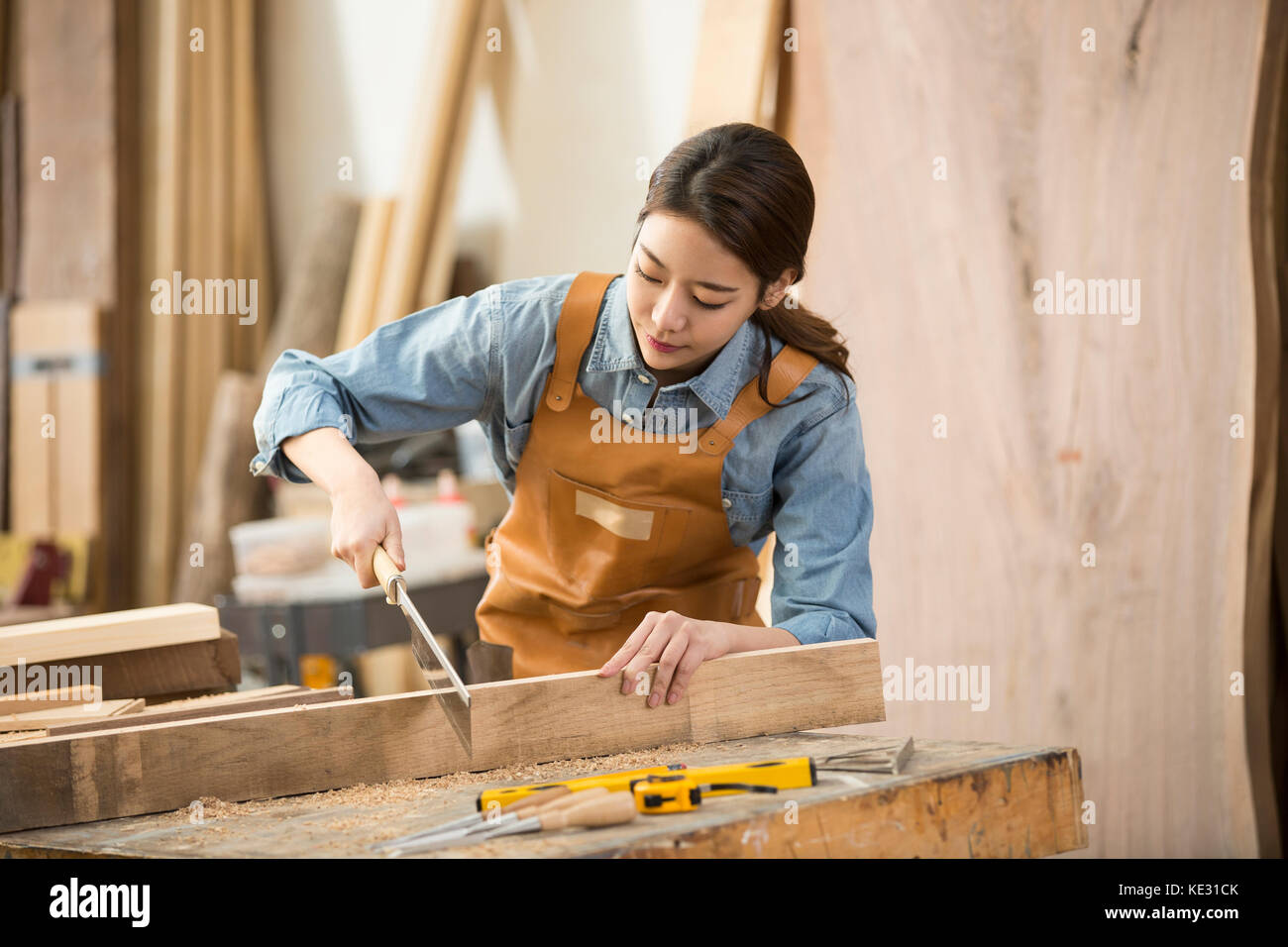 Young female woodworker concentrating on her work Stock Photo - Alamy
