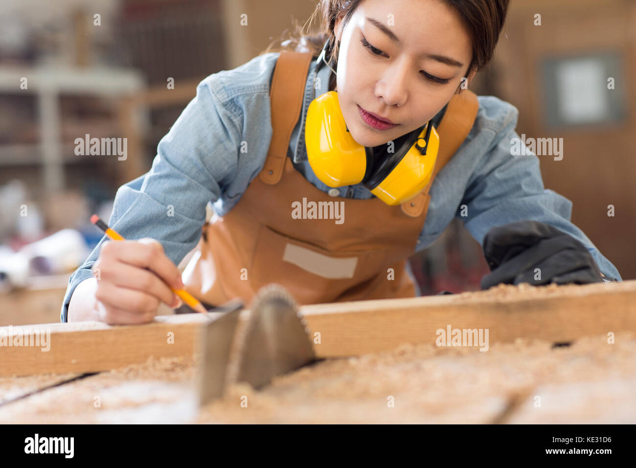 Portrait of young female woodworker concentrating on her work Stock ...