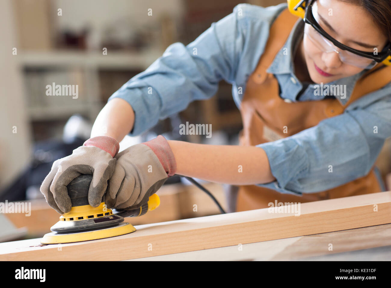 Portrait of young female woodworker concentrating on her work Stock ...
