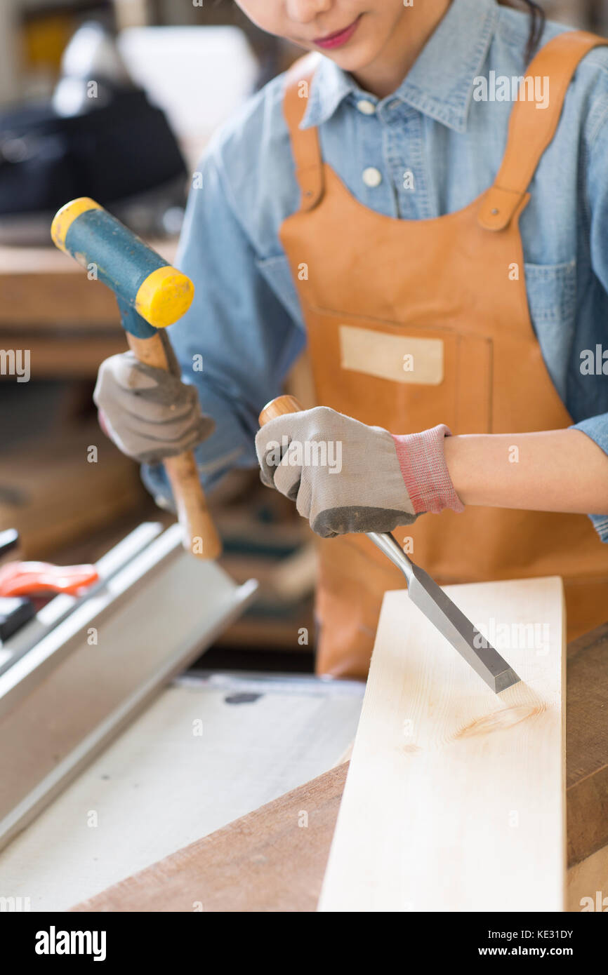 Young female woodworker concentrating on her work Stock Photo - Alamy