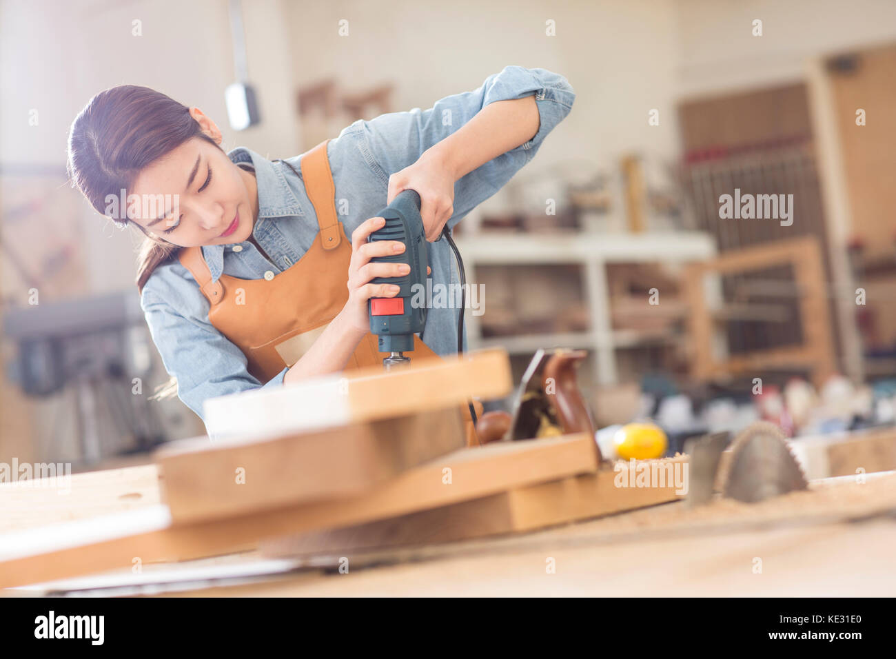 Portrait of young female woodworker concentrating on her work Stock ...