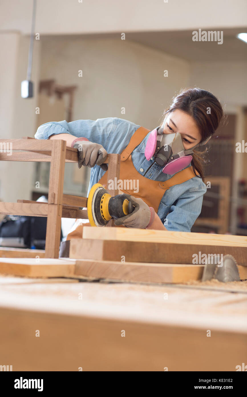 Portrait of young female woodworker concentrating on her work Stock ...