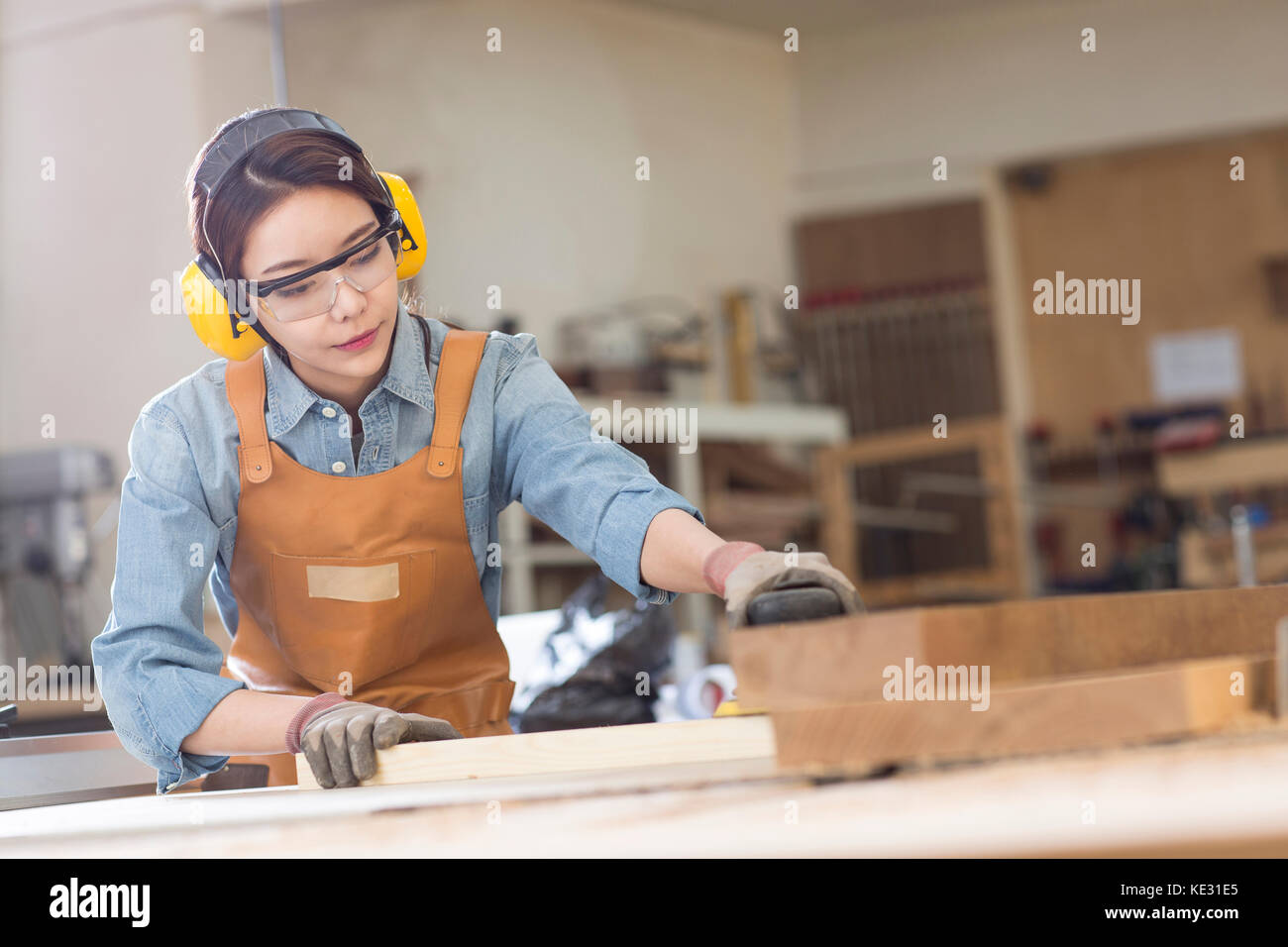 Portrait of young female woodworker concentrating on her work Stock ...