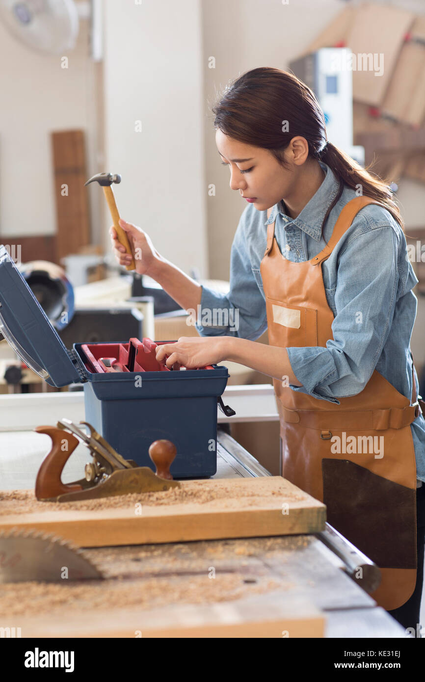 Side view of young female woodworker concentrating on her work Stock ...